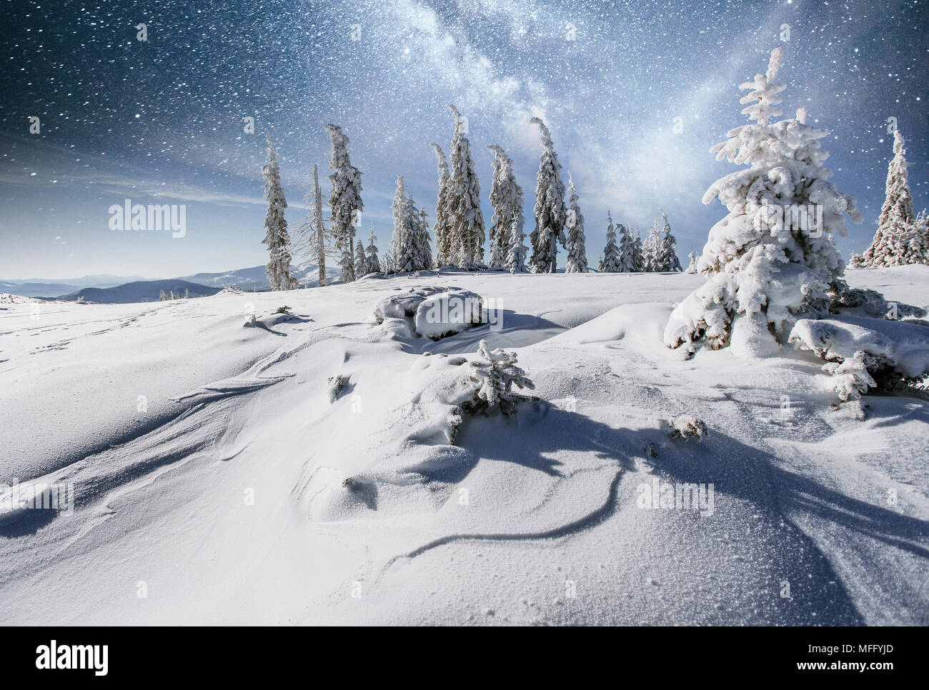 starry sky in winter snowy night. fantastic milky way in the New Year's Eve. Starry sky snowy ...