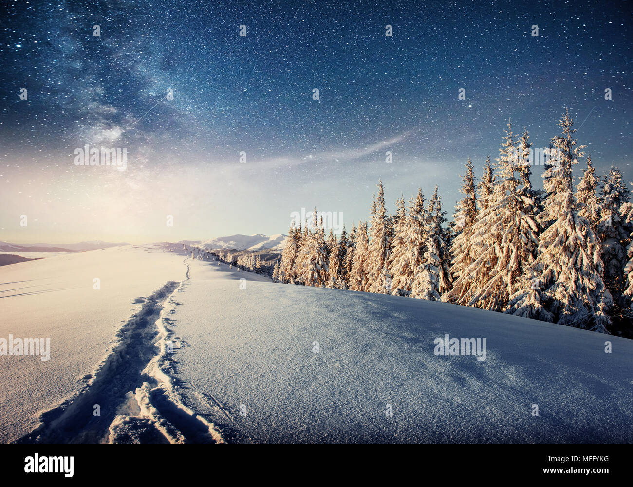 starry sky in winter snowy night. fantastic milky way in the New Year's Eve. Starry sky snowy ...