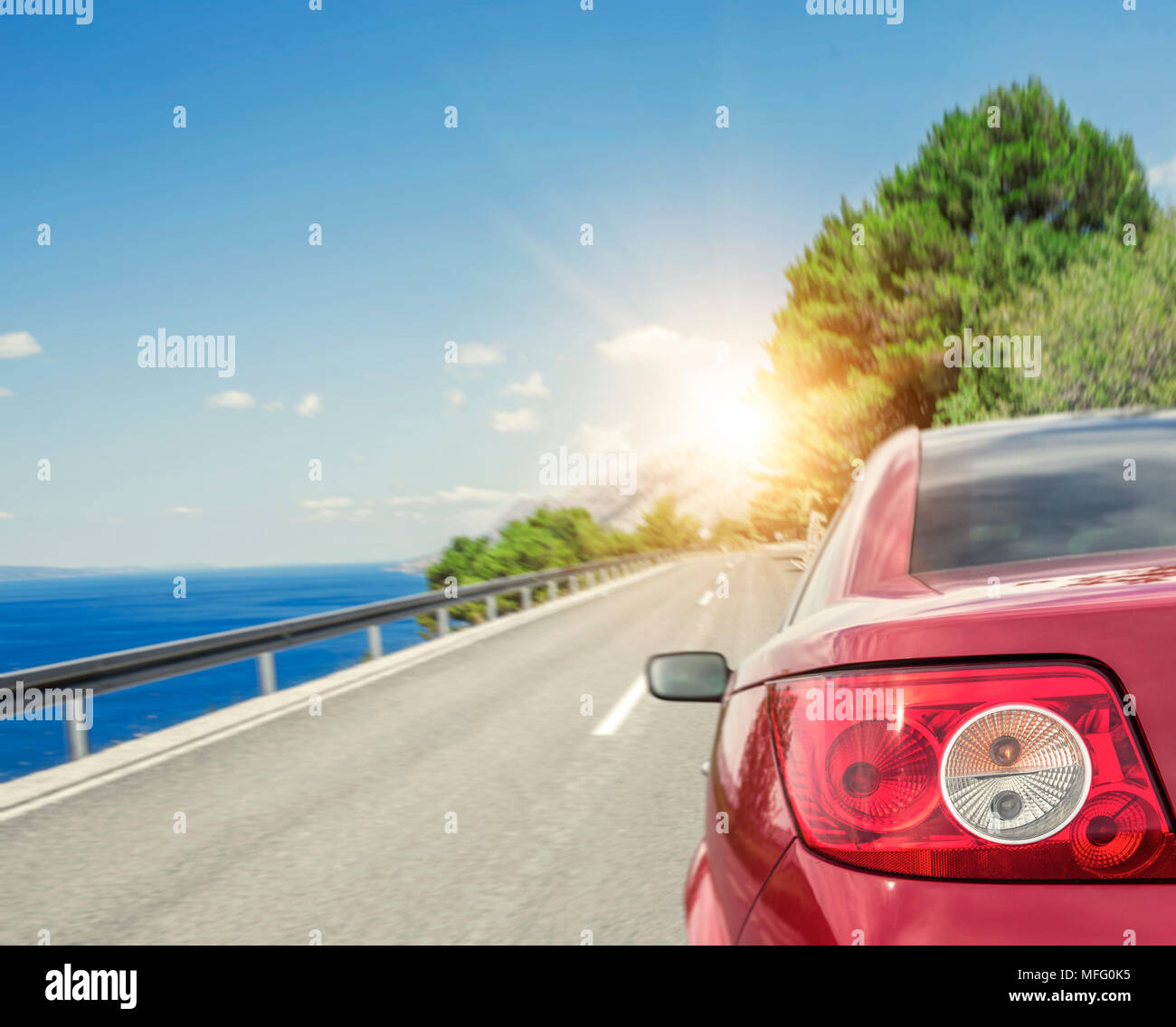 Red car rushing along a high-speed highway Stock Photo - Alamy
