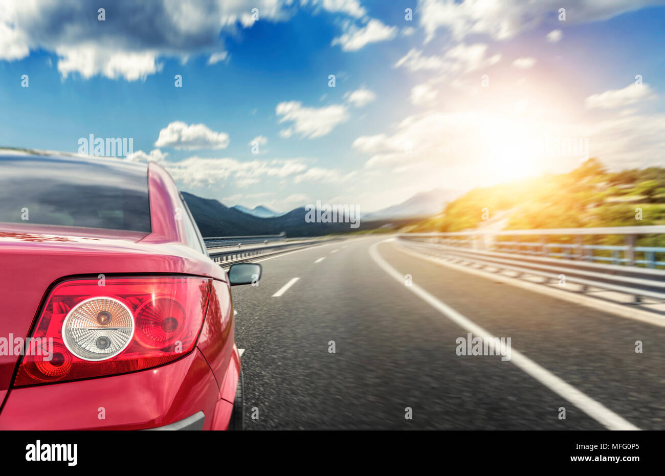 Red car rushing along a high-speed highway Stock Photo - Alamy