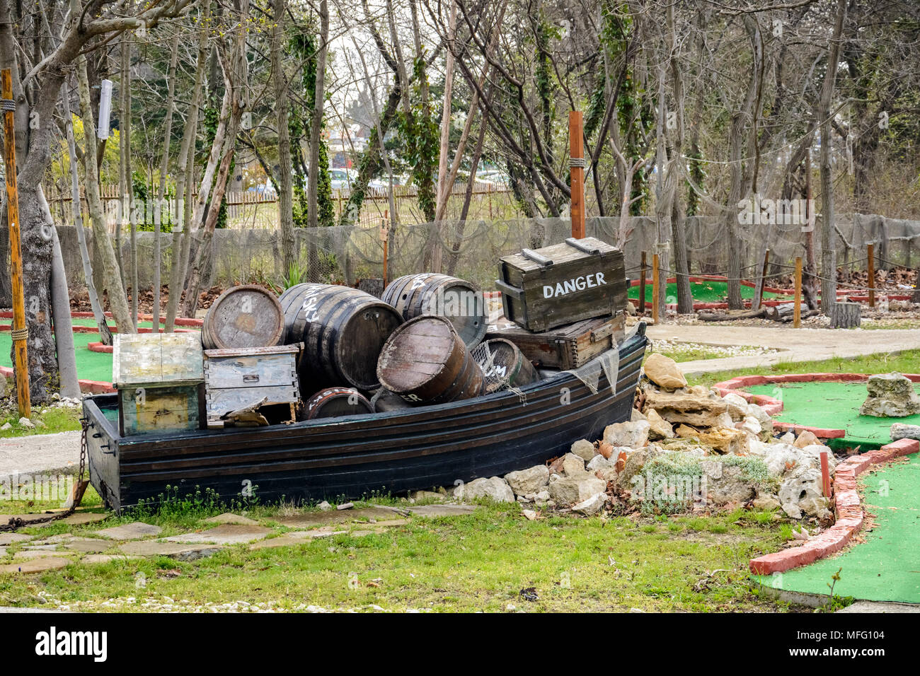 Decorative boat full of crate and barrel on a mini golf Stock Photo - Alamy