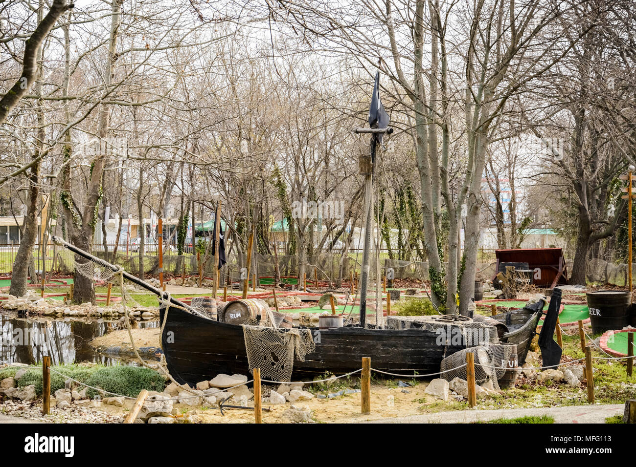 Decorative boat full of crate and barrel on a mini golf Stock Photo - Alamy