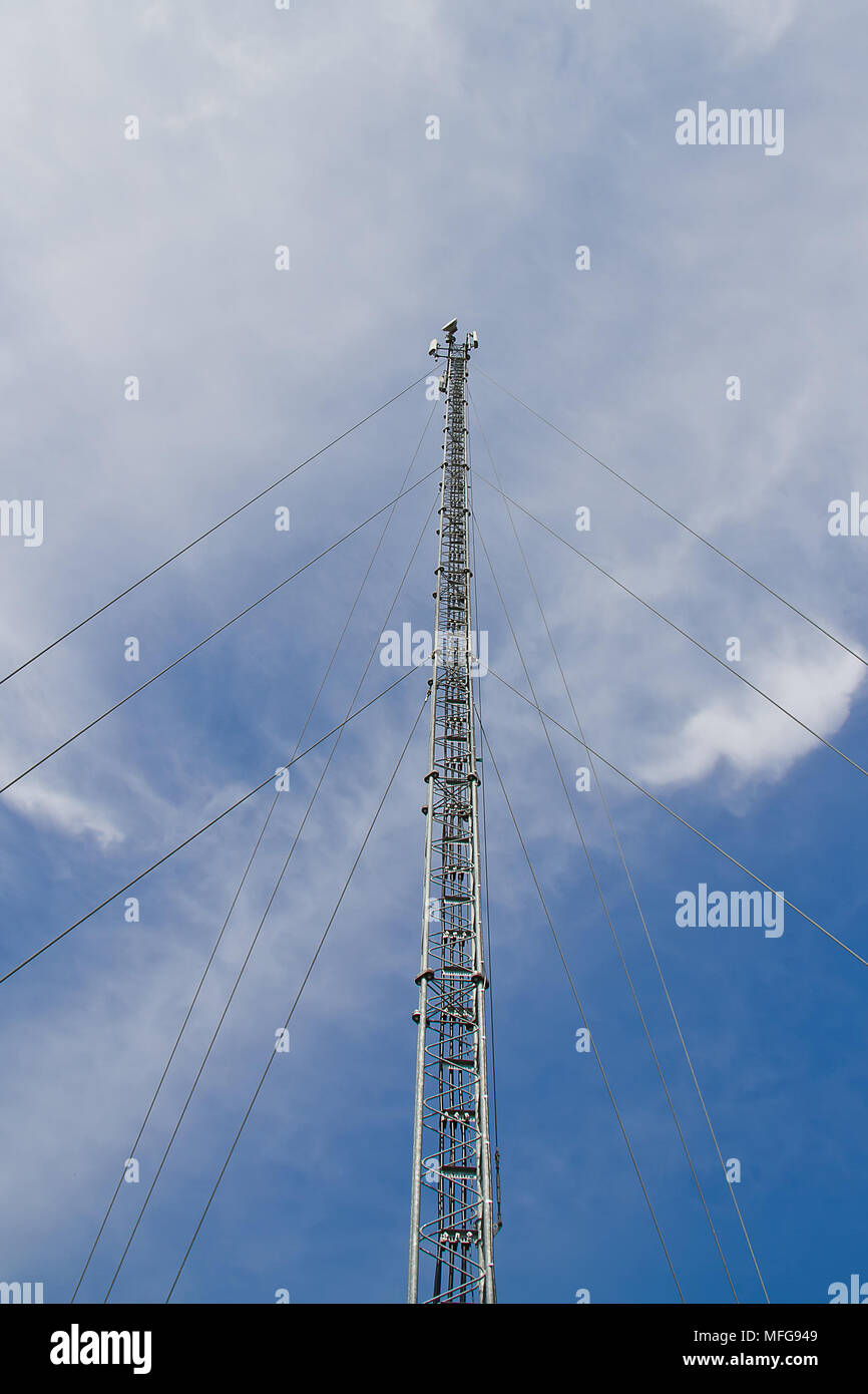 Cell Phone Tower with stretching ropes in a countryside Stock Photo - Alamy