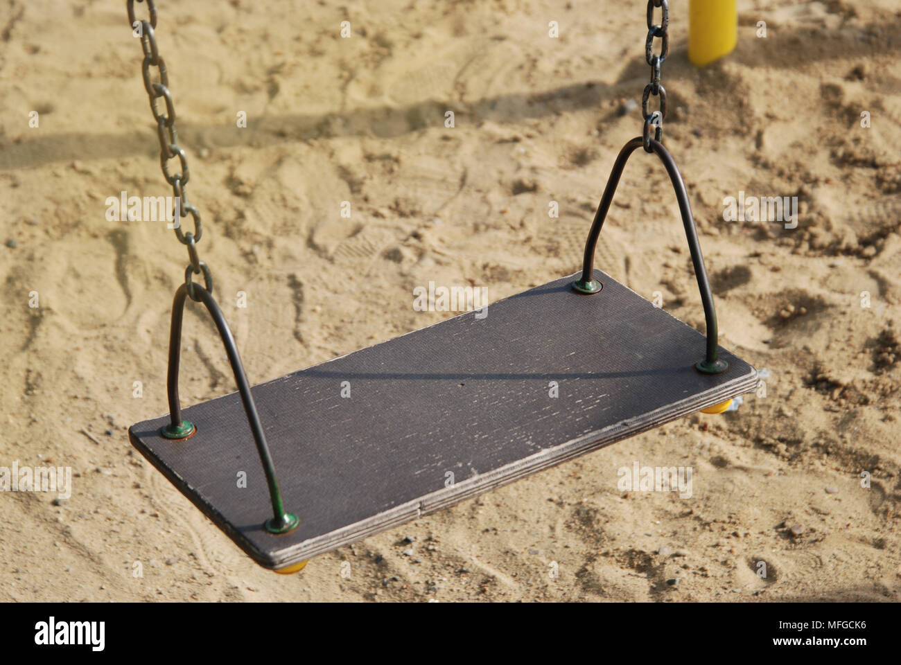 Empty Metal Chain Swing in Playground Sand Background Stock Photo - Alamy