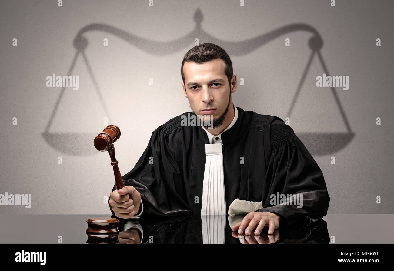Young handsome judge in black gown making decision Stock Photo - Alamy