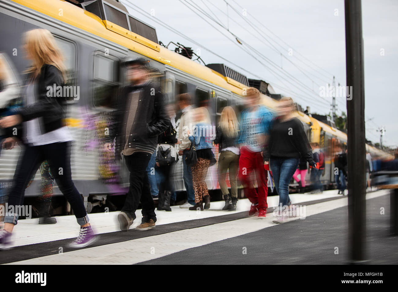 Morning rush hour at the train station with many teenage students ...
