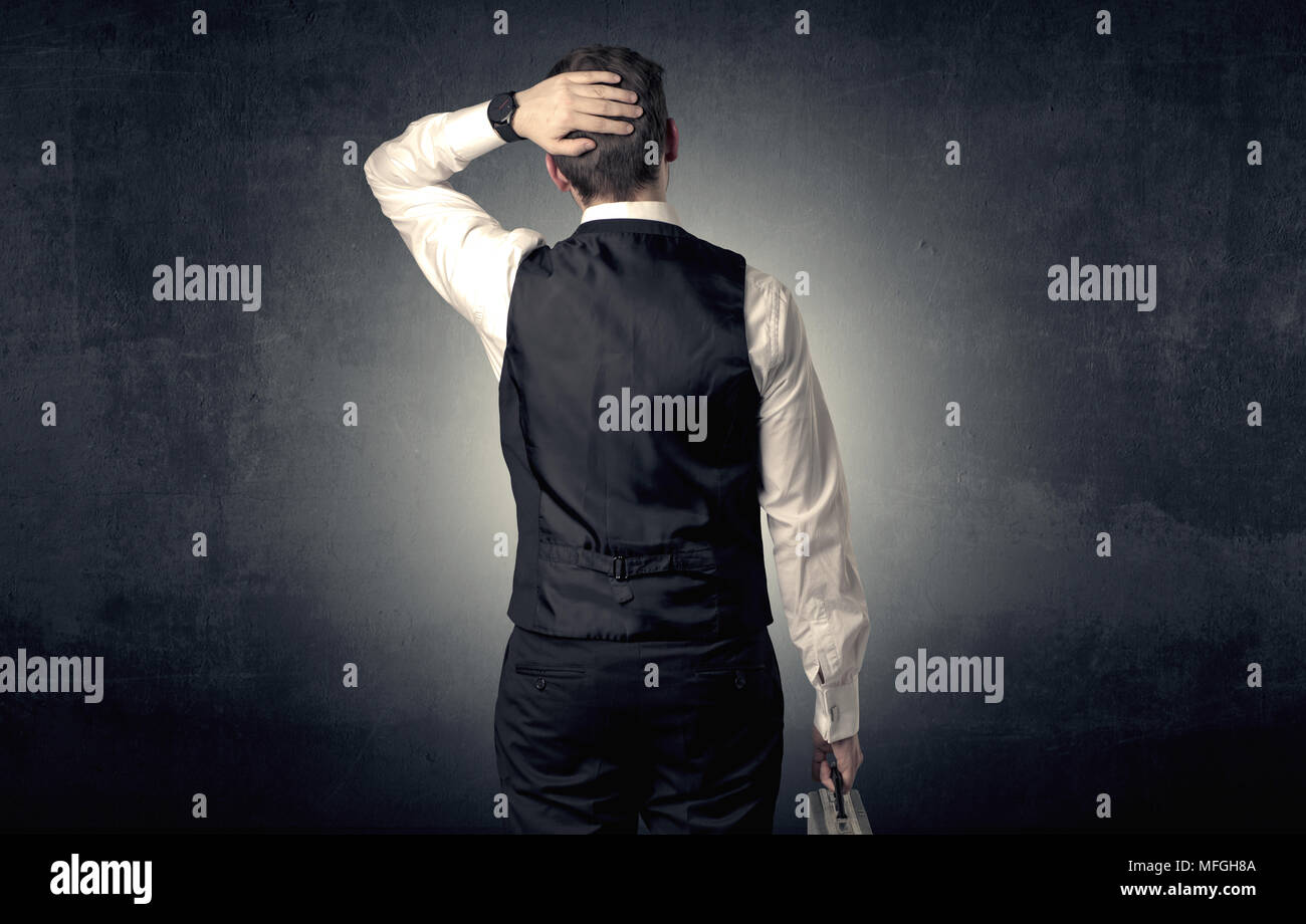 Young businessman standing and thinking alone Stock Photo - Alamy