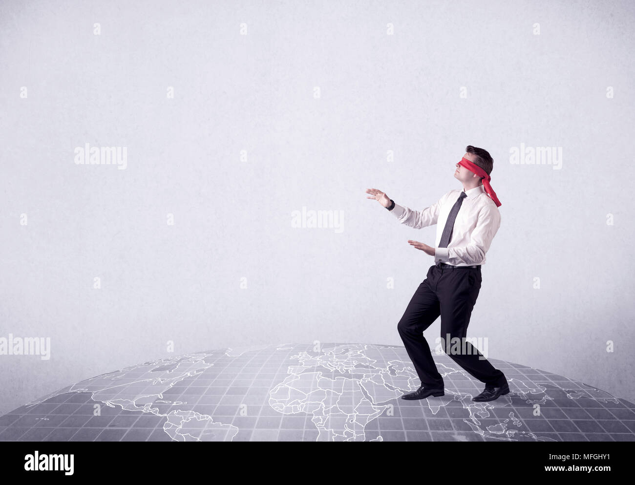 Young blindfolded businessman steps on a grey world map Stock Photo - Alamy