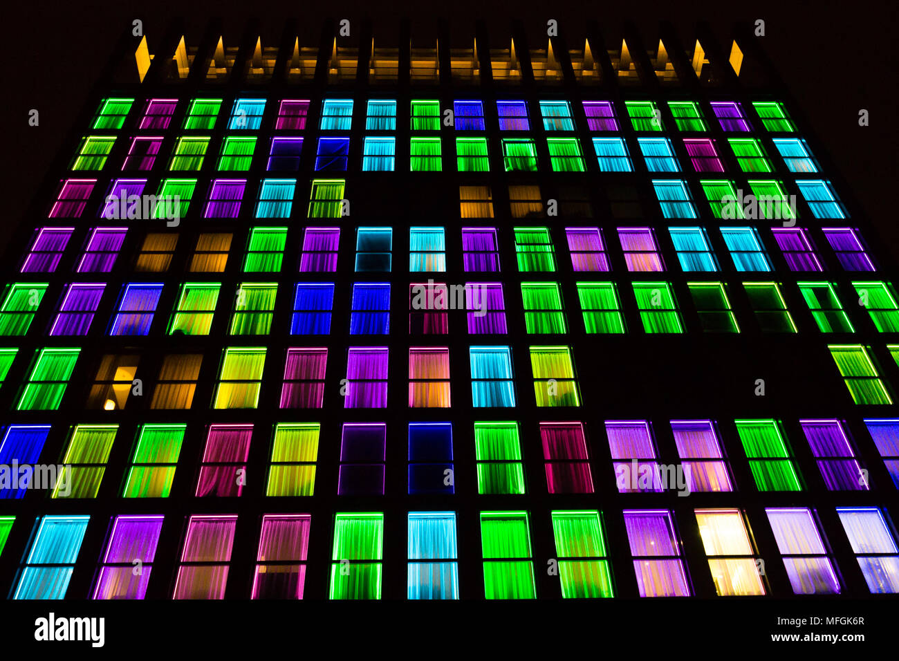 Colored windows texture. Windows illuminated by neon lights background ...