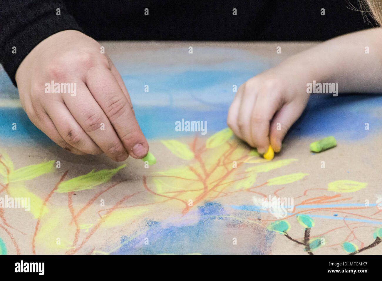 The child paints chalks together with his mother Stock Photo - Alamy