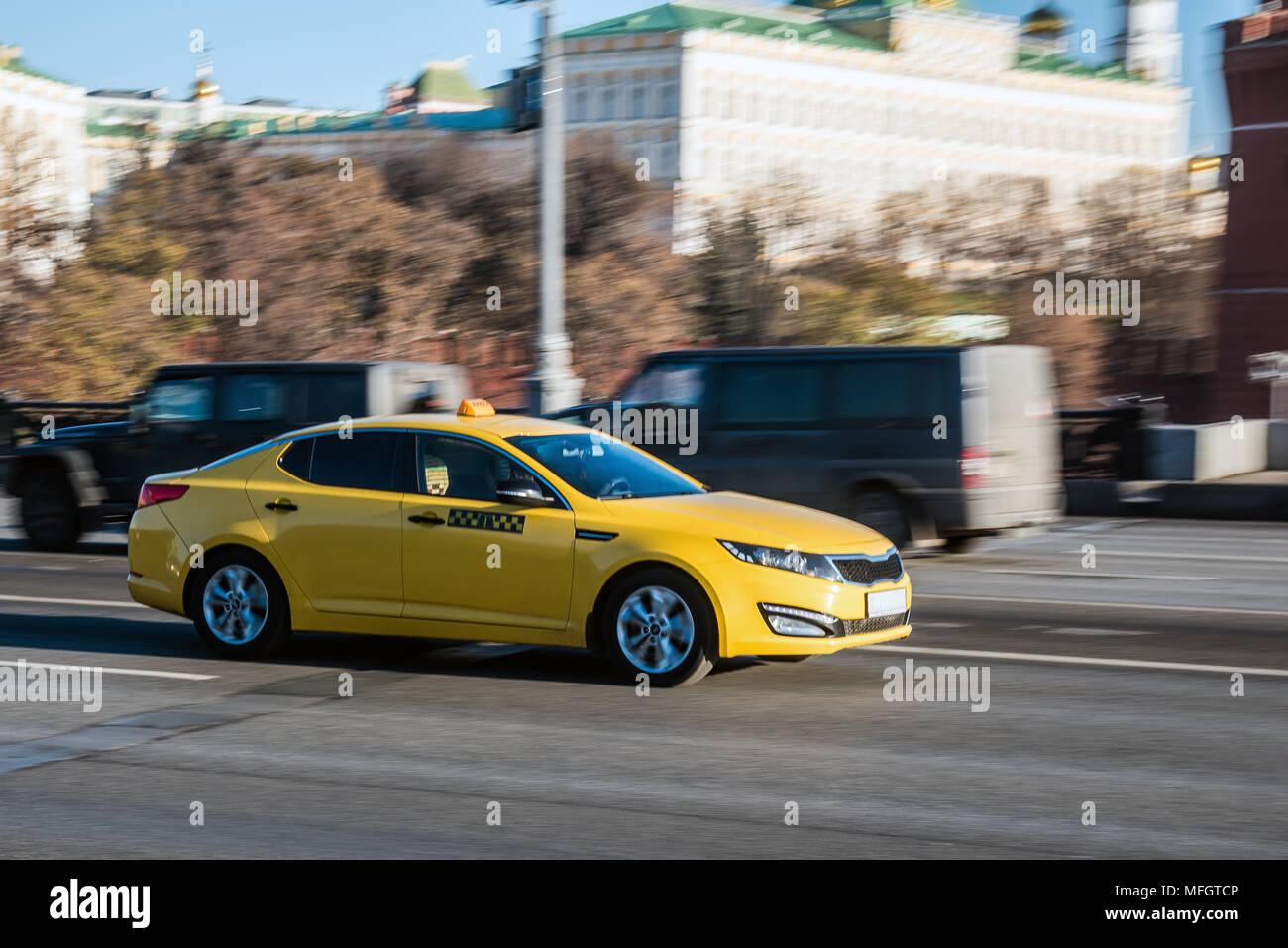 Yellow taxi cab in motion on a street in big city centre Stock Photo ...