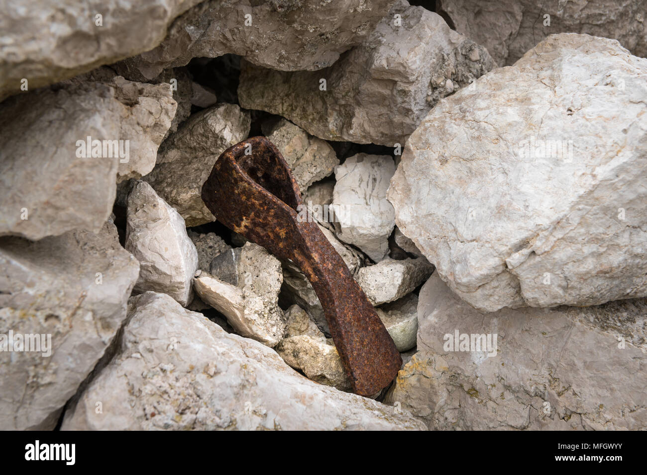 Old rusty ax without handle lying between rocks in Croatia Stock Photo ...