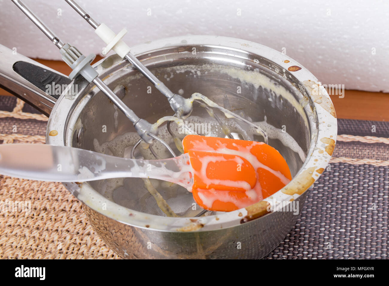 Dirty kitchenware. Spatula and mixer in bowl after cooking. Photo can ...