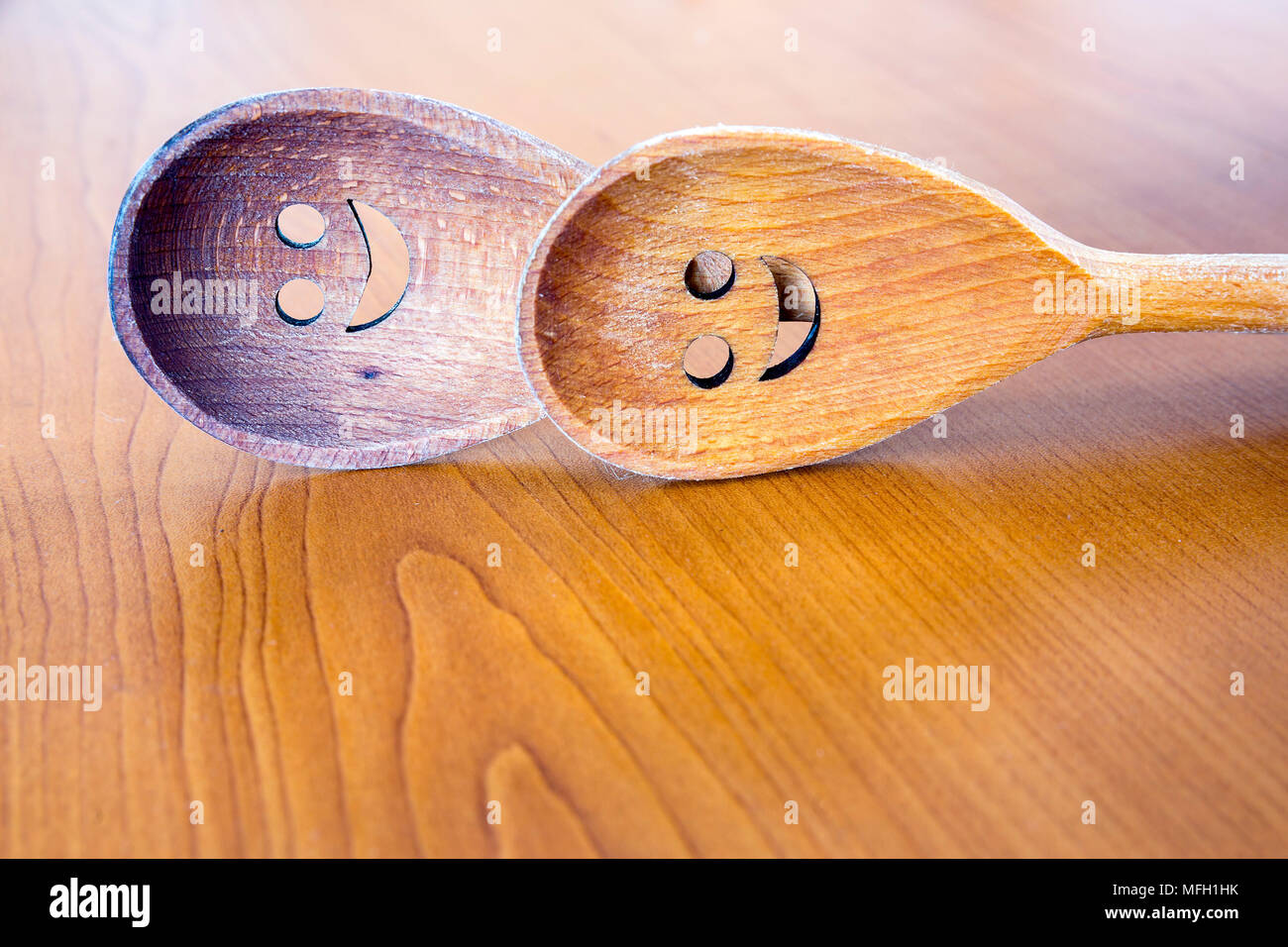 Wooden smiley face spoon on a wooden background. Studio shot. Set of kitchen utensil Stock Photo ...