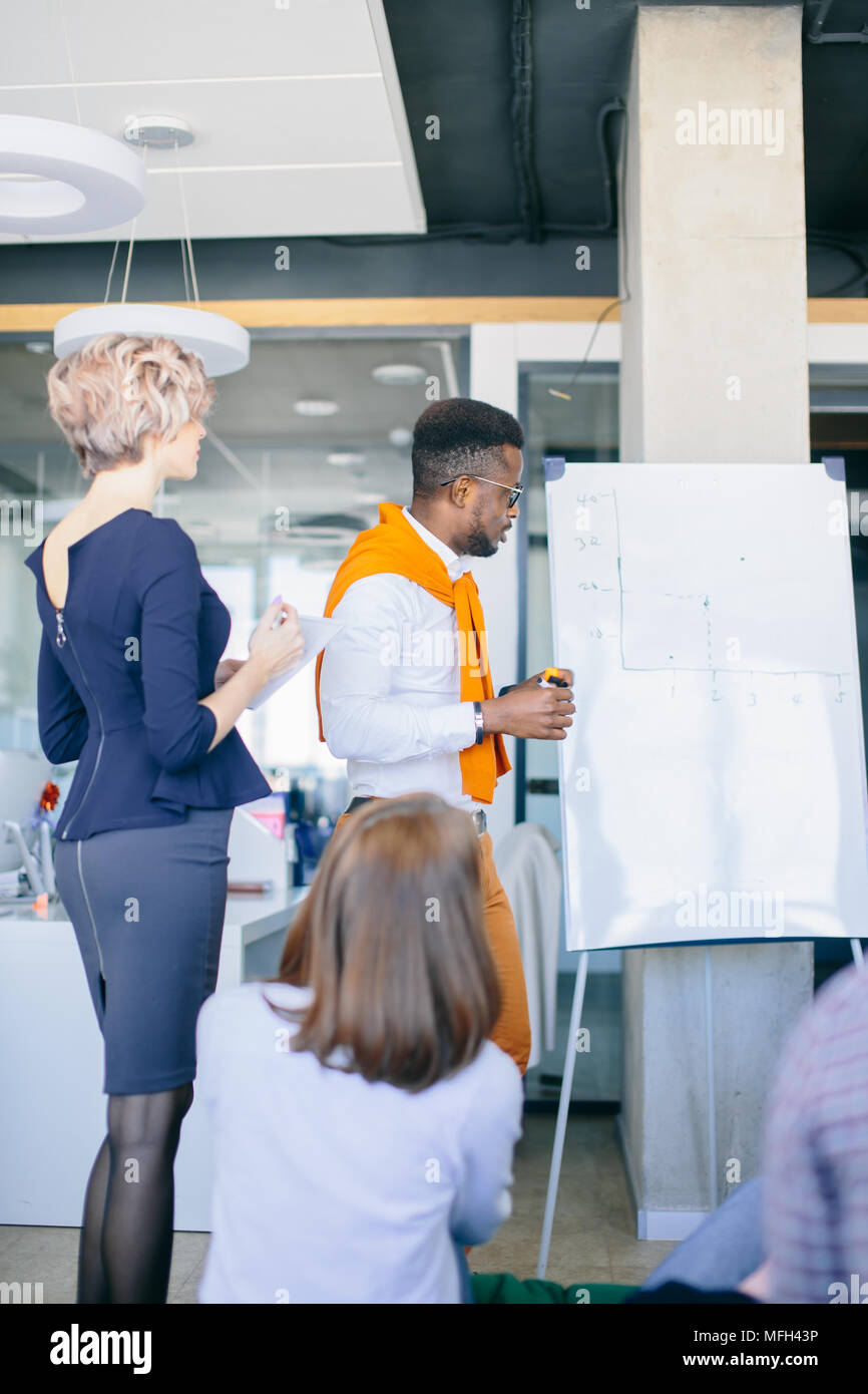 vertical photo of african male writing something on whiteboard Stock ...