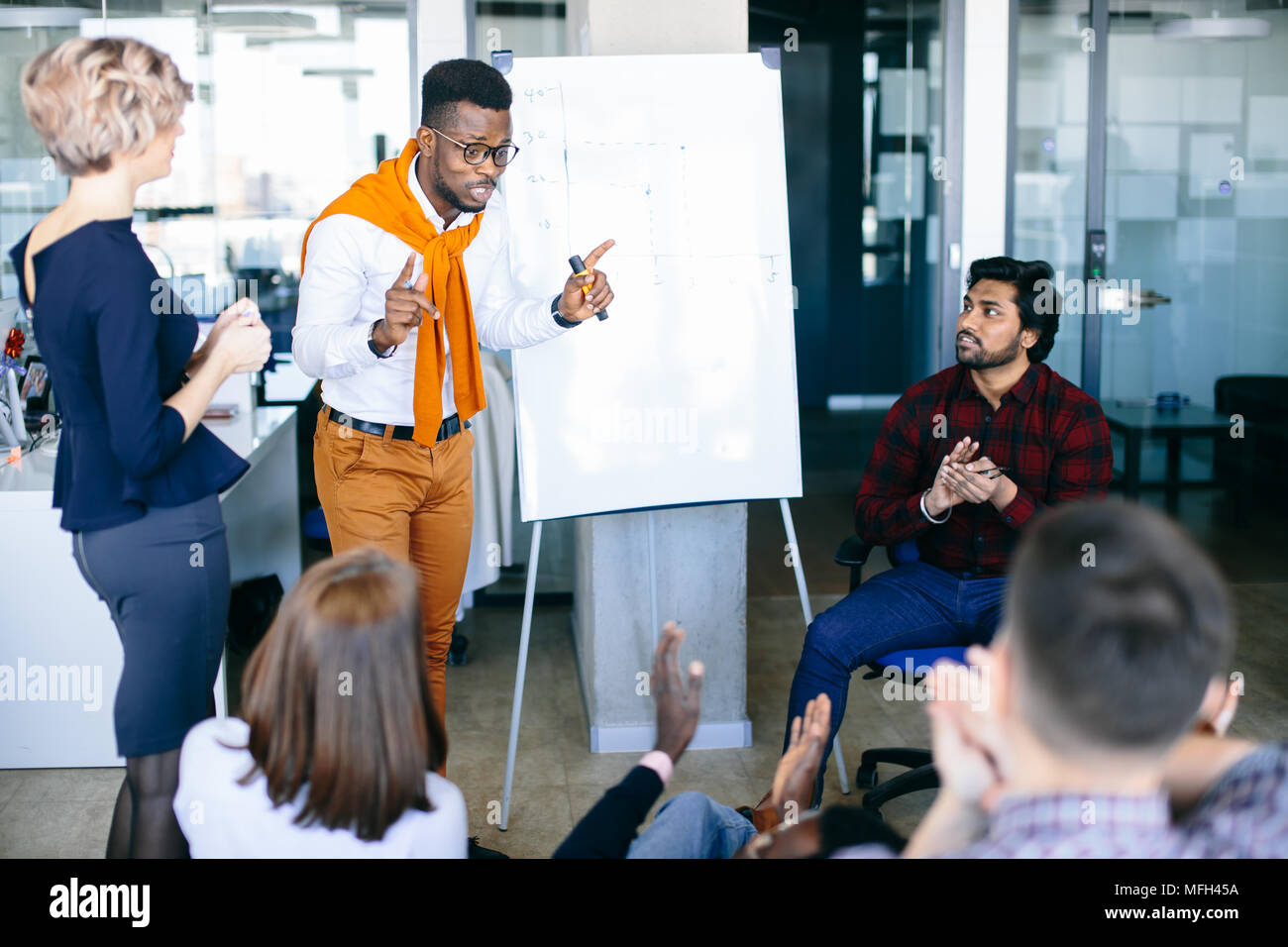 experienced black business man presenting plan, tasks to multi ethnic ...