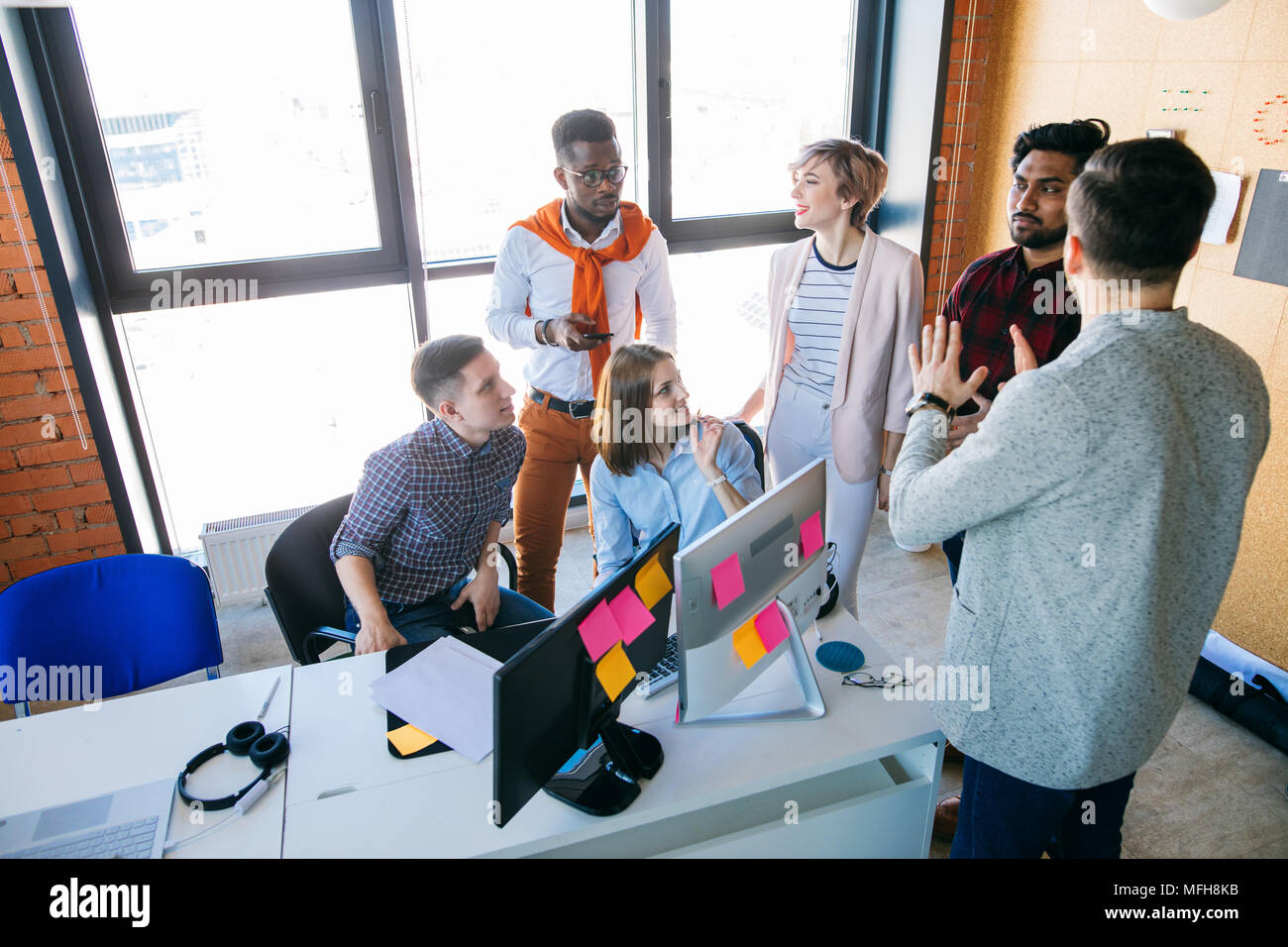 ambitious diverse web-designers are discussing their perspective plans ...