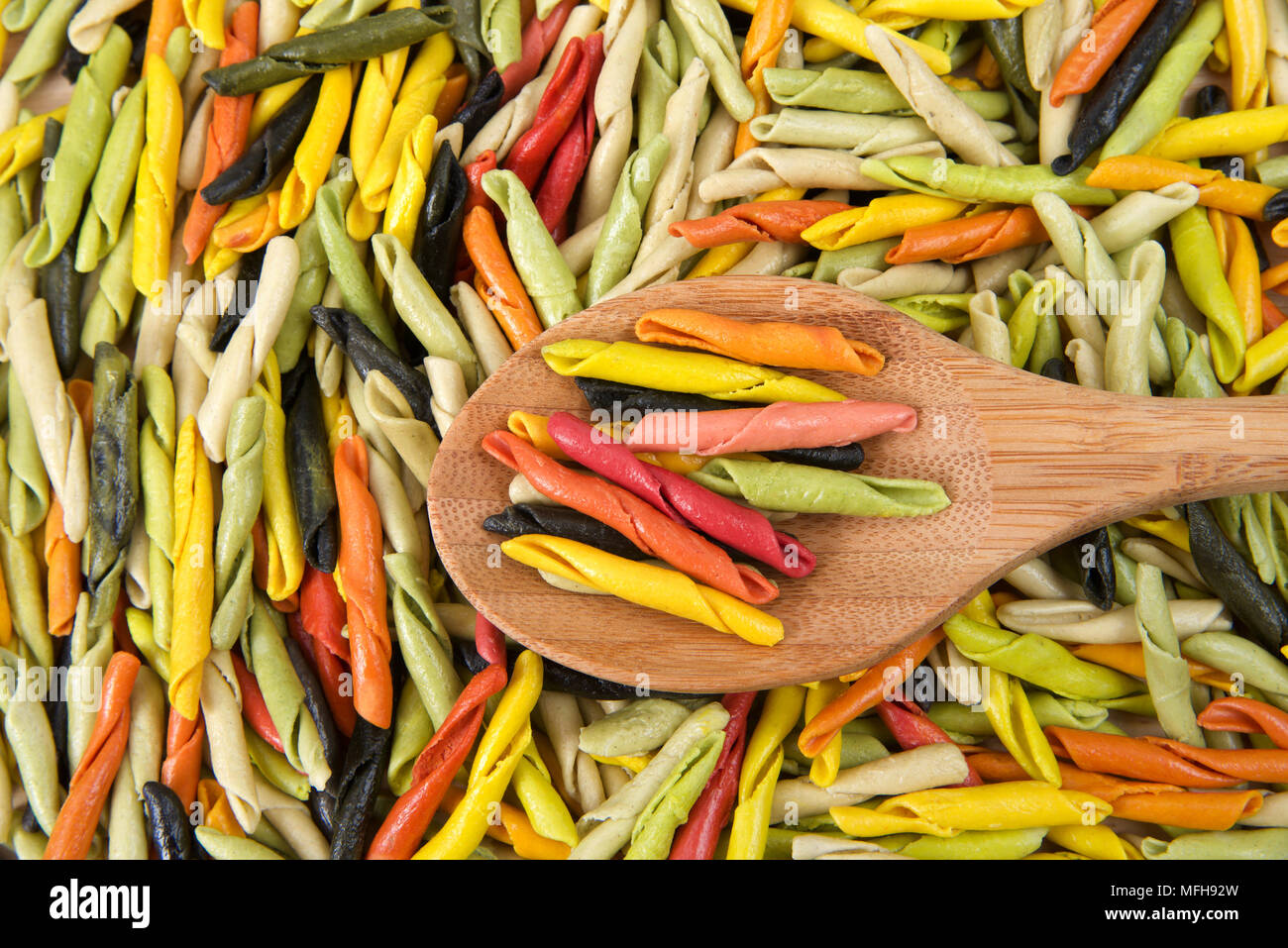 Background of bright colorful hand rolled dry pasta made from ...