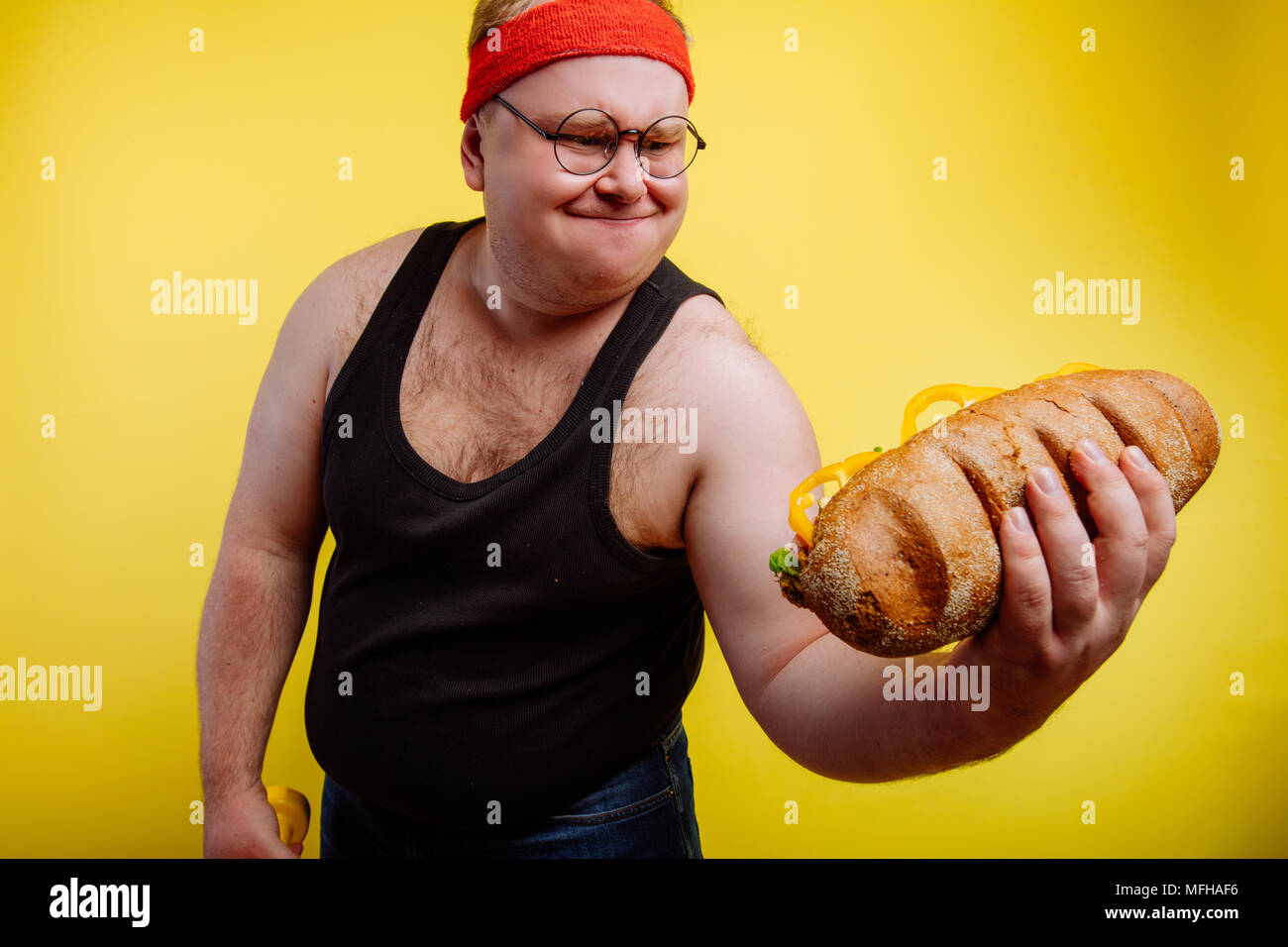 Fatigued funny fat man sweats while lifting burger Stock Photo - Alamy