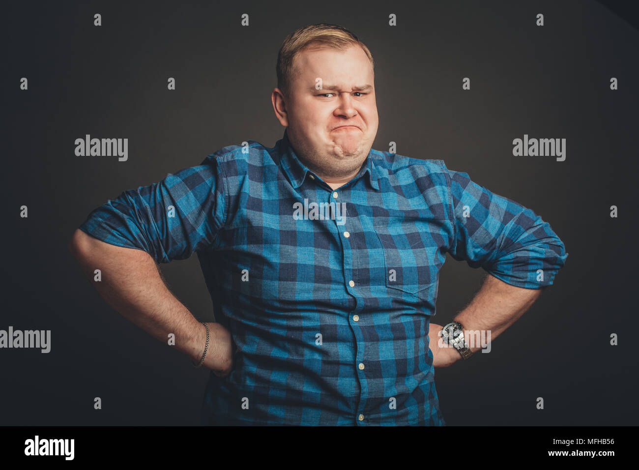 fat proud young man on black background Stock Photo - Alamy
