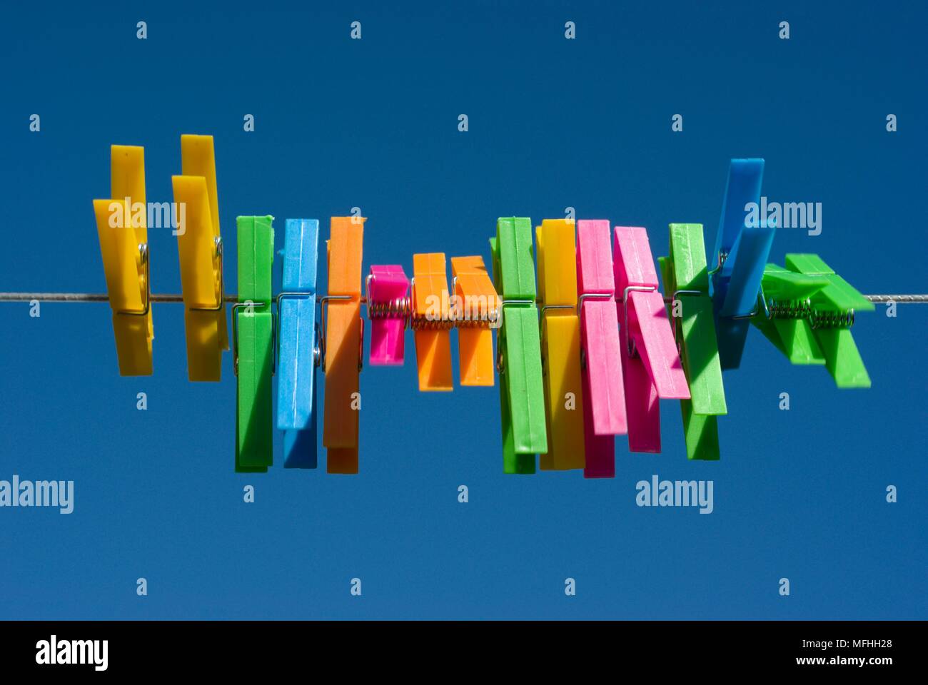 Multi coloured pegs Stock Photo - Alamy