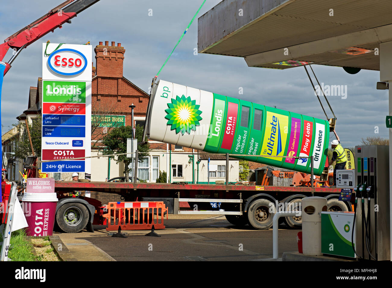 Replacing BP sign with Esso sign at a petrol station in Peterborough ...