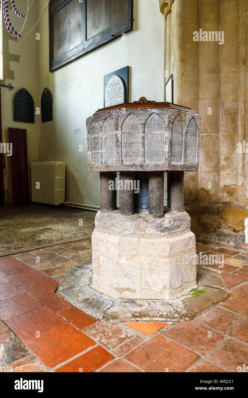 Traditional stone baptismal font in St Peter & St Paul church, Aston ...