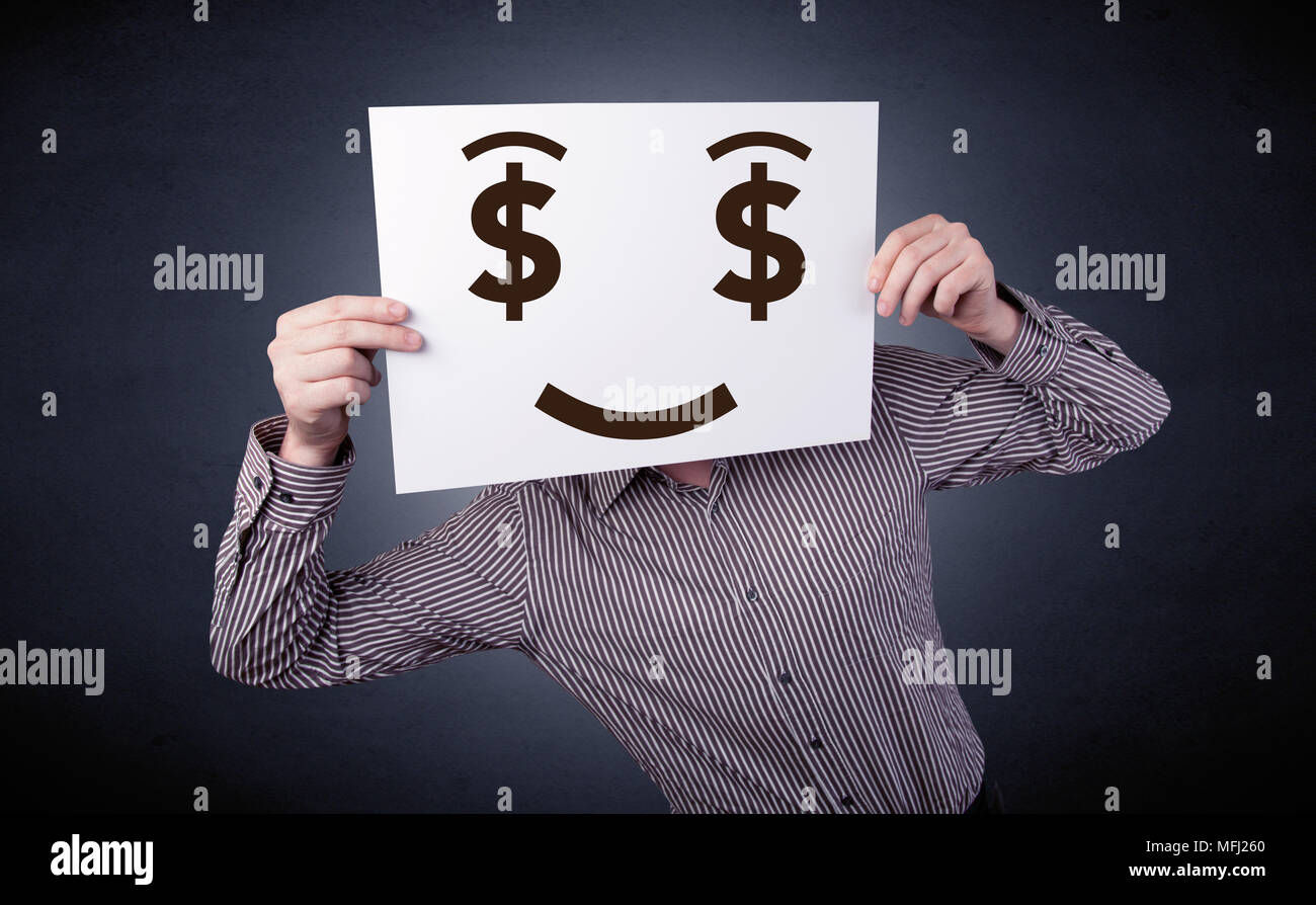 Young casual businessman hiding behind a greedy face drawing on ...