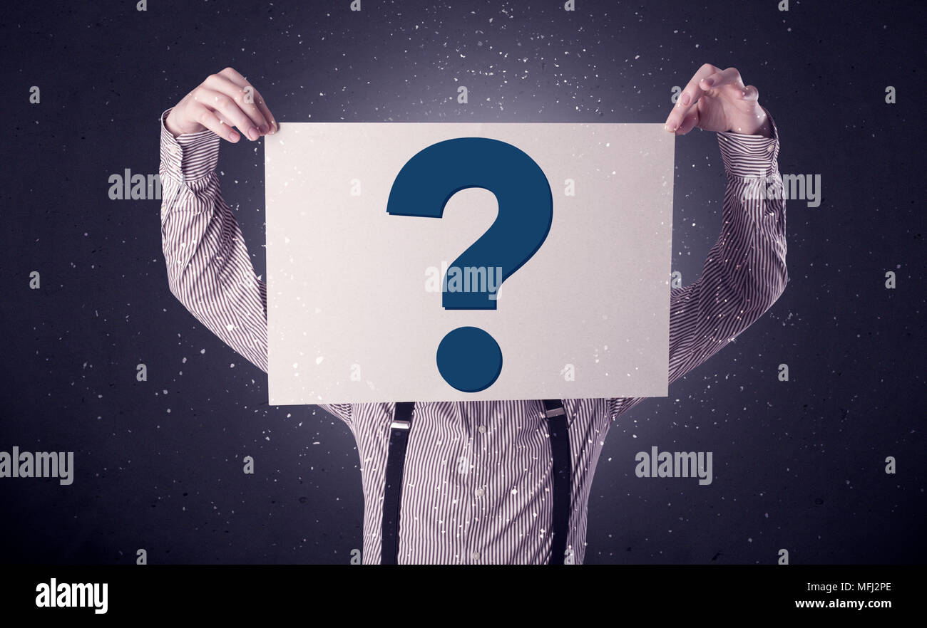 Young businessman hiding behind a question mark drawn on paper Stock ...