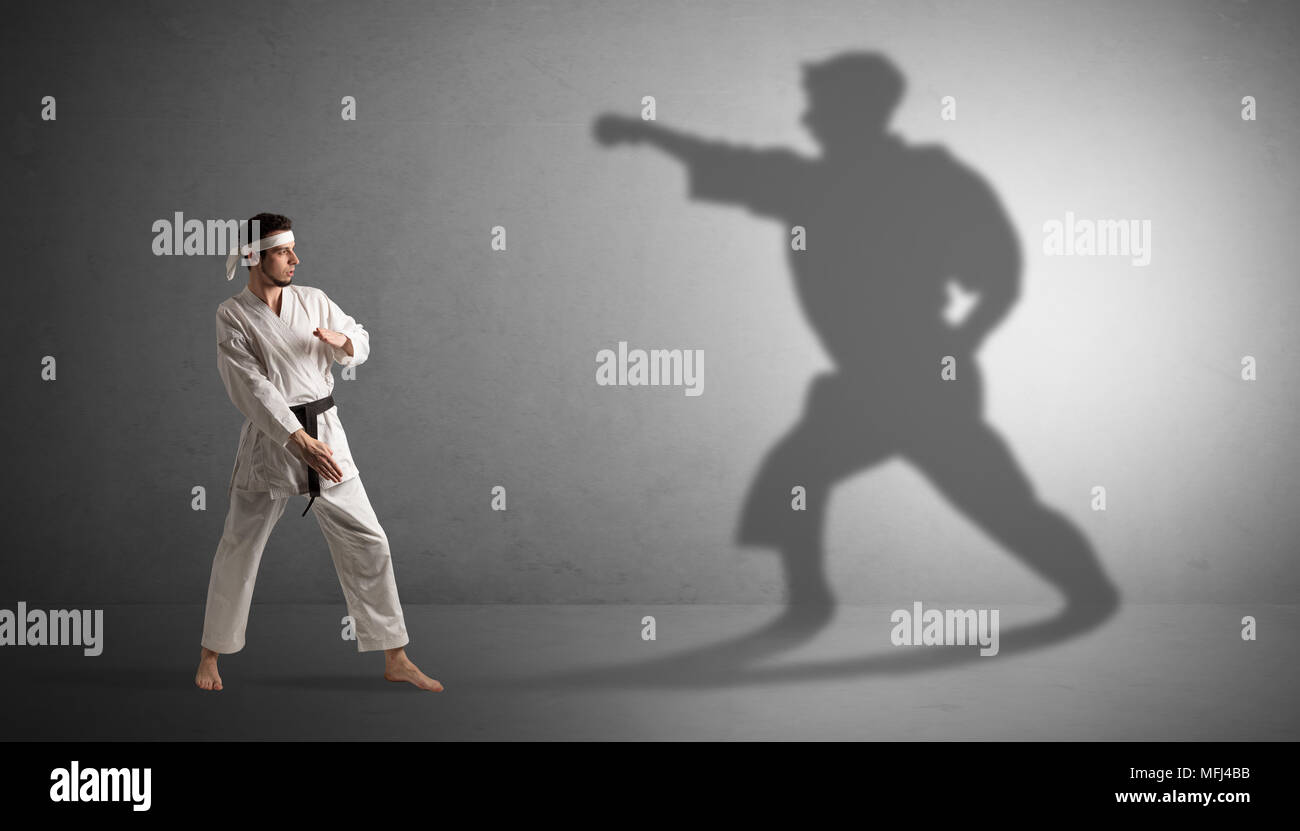 Young karate man confronting with his own shadow Stock Photo - Alamy