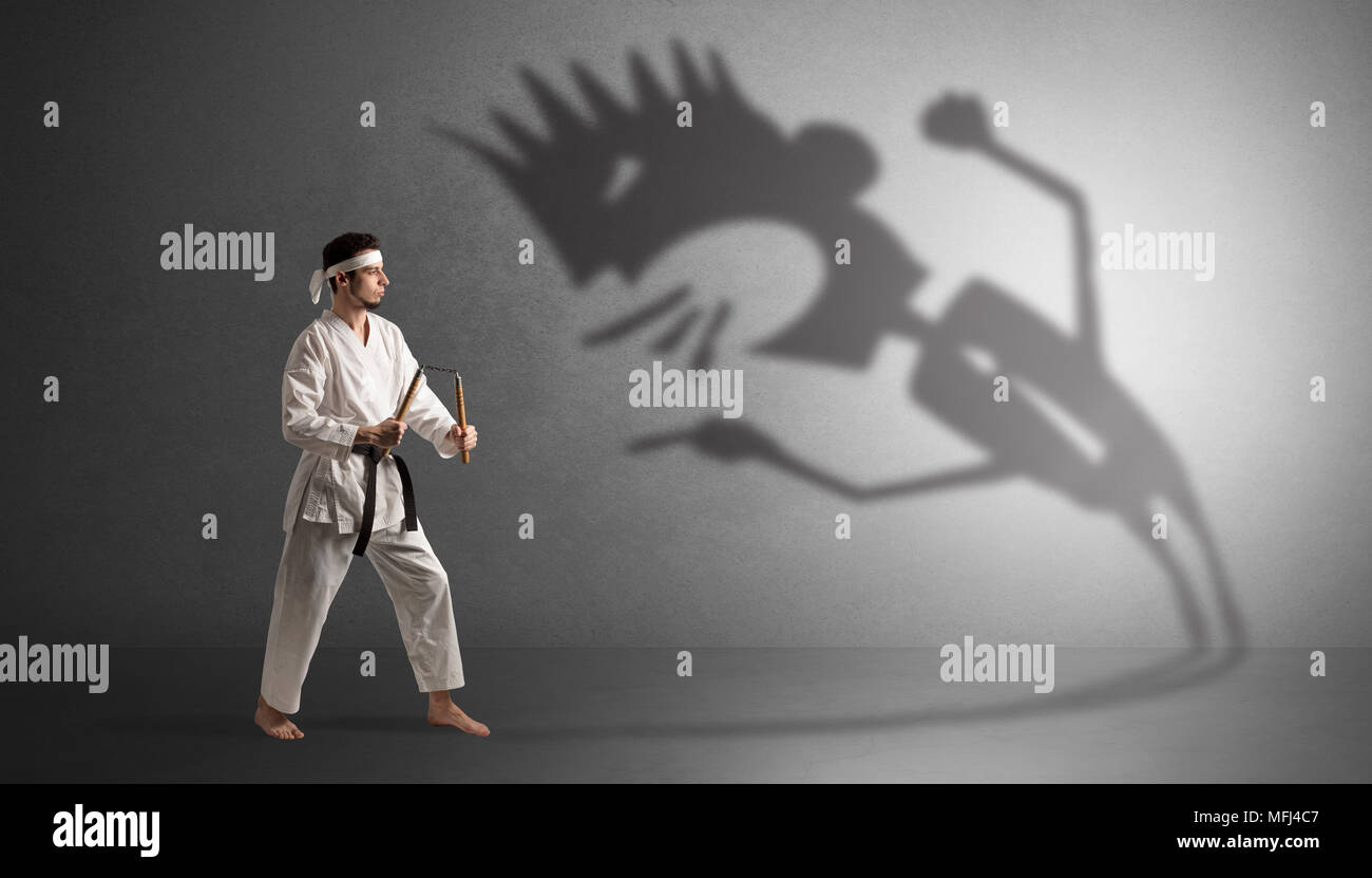 Young karate man fighting with a big black scary shadow Stock Photo - Alamy
