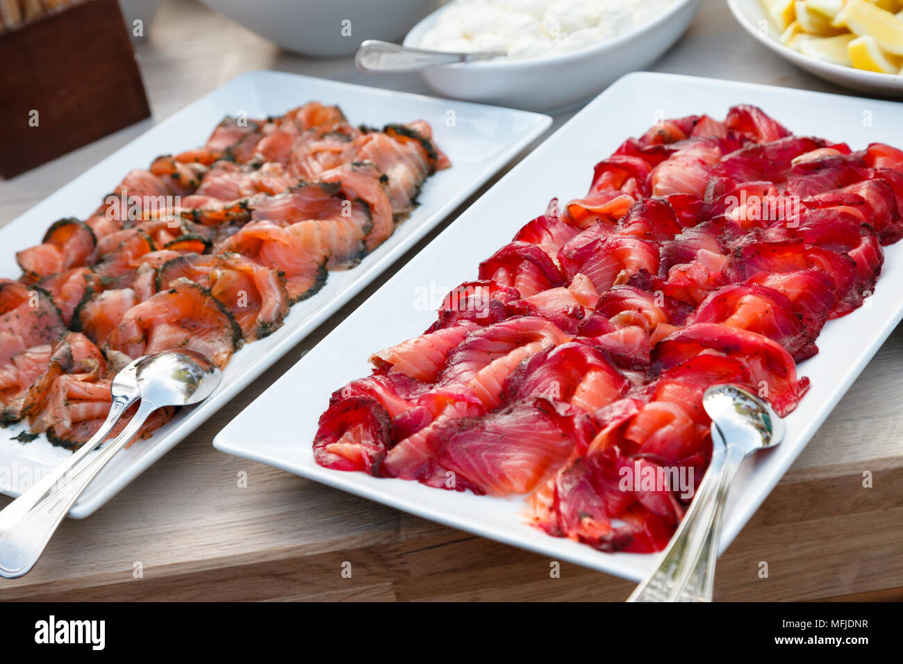 Slices of smoked salmon fish arranged on plates Stock Photo - Alamy