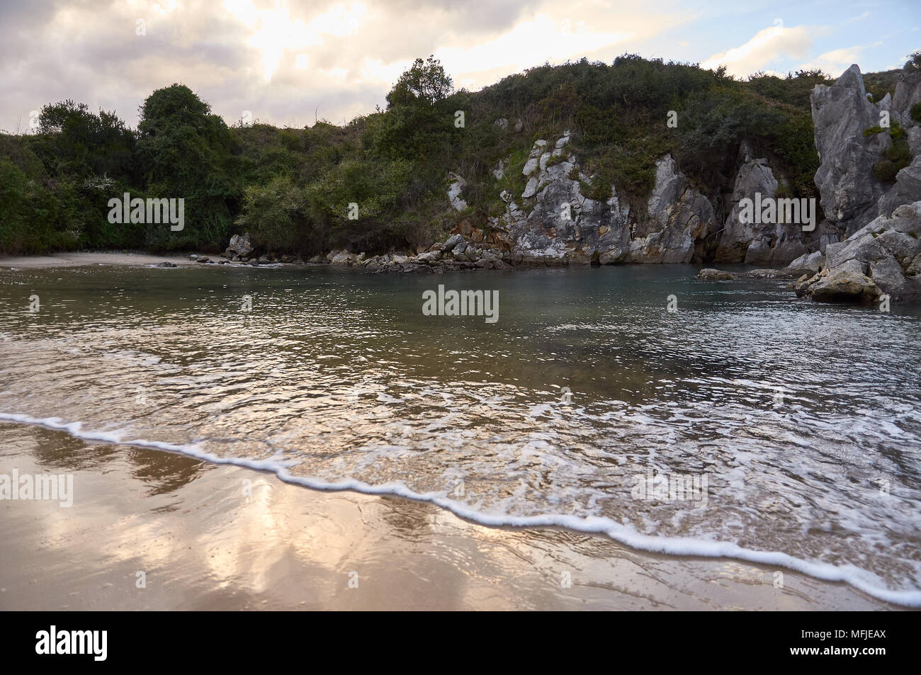 Sunset at Gulpiyuri beach, which is an inland beach arose in flooded ...