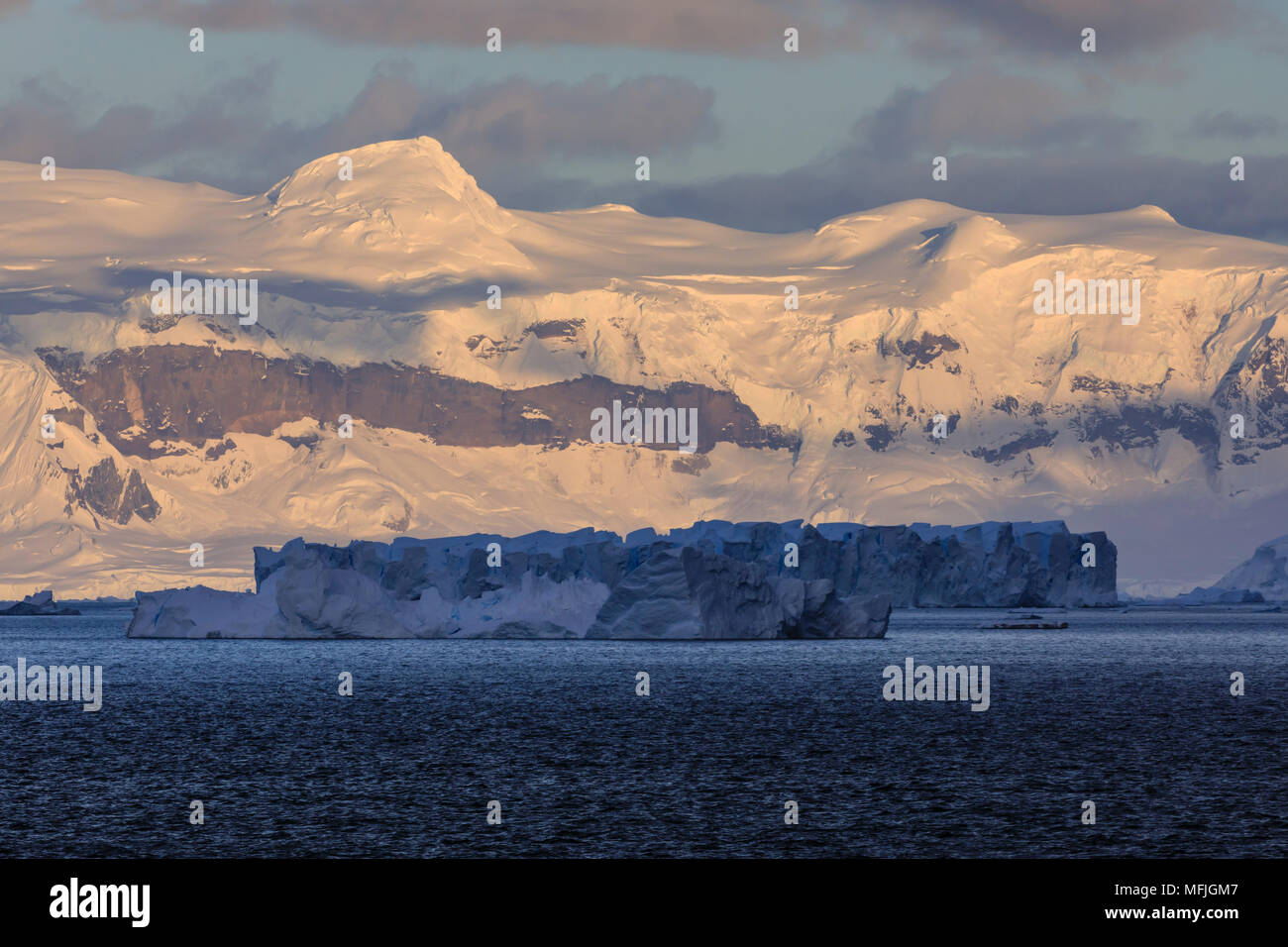 Sunrise, with atmospheric cloud and mist, mountains, glaciers and ...