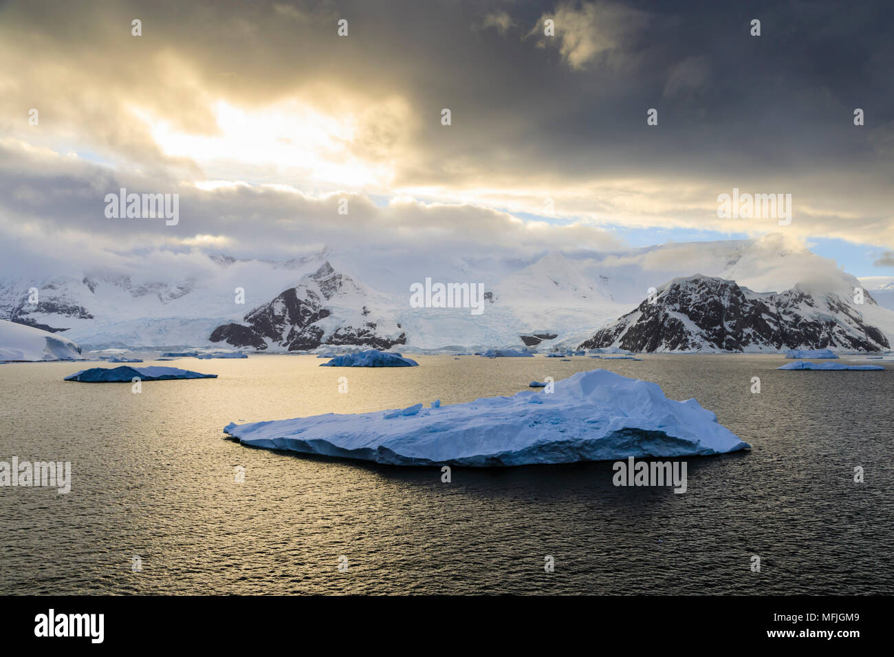 Sunrise, with atmospheric cloud and mist, mountains, glaciers and ...