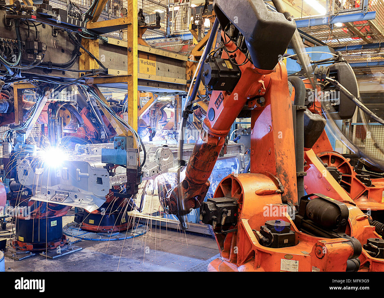 FILED - 24 April 2018, Germany, Cologne: Robots welding a vehicle body ...