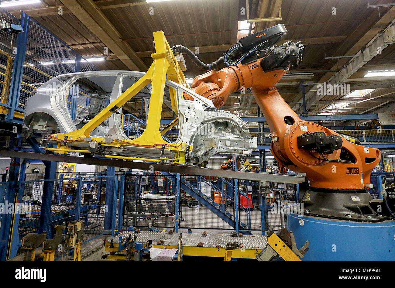 FILED - 24 April 2018, Germany, Cologne: A robot moves a vehicle body ...