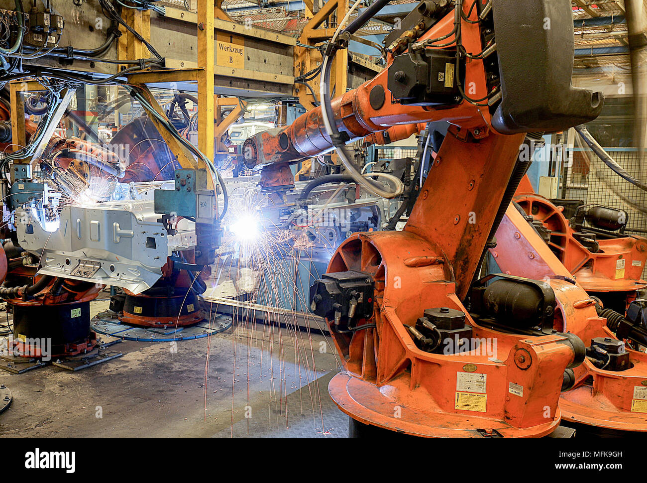 FILED - 24 April 2018, Germany, Cologne: Robots welding a vehicle body ...