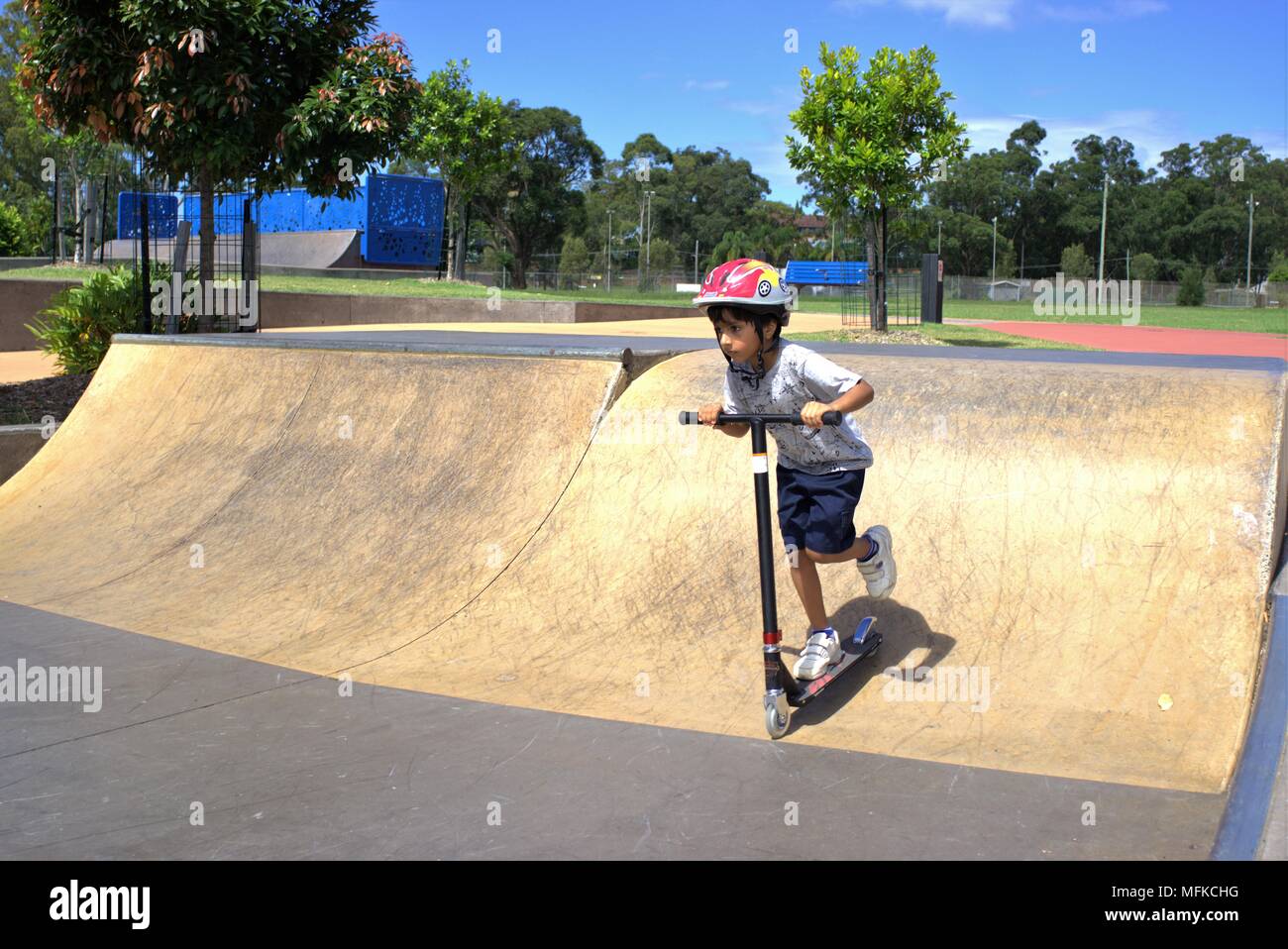Kid riding scooter at park in Australia. Active kid playing with ...
