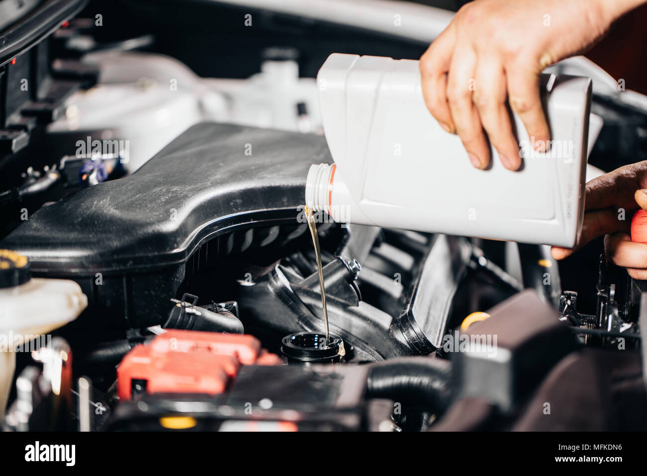 Pouring oil to car engine, close up Stock Photo - Alamy