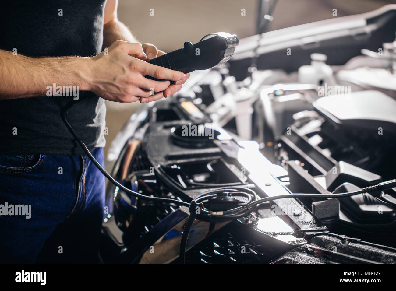Auto mechanic testing electrical system on automobile Stock Photo - Alamy