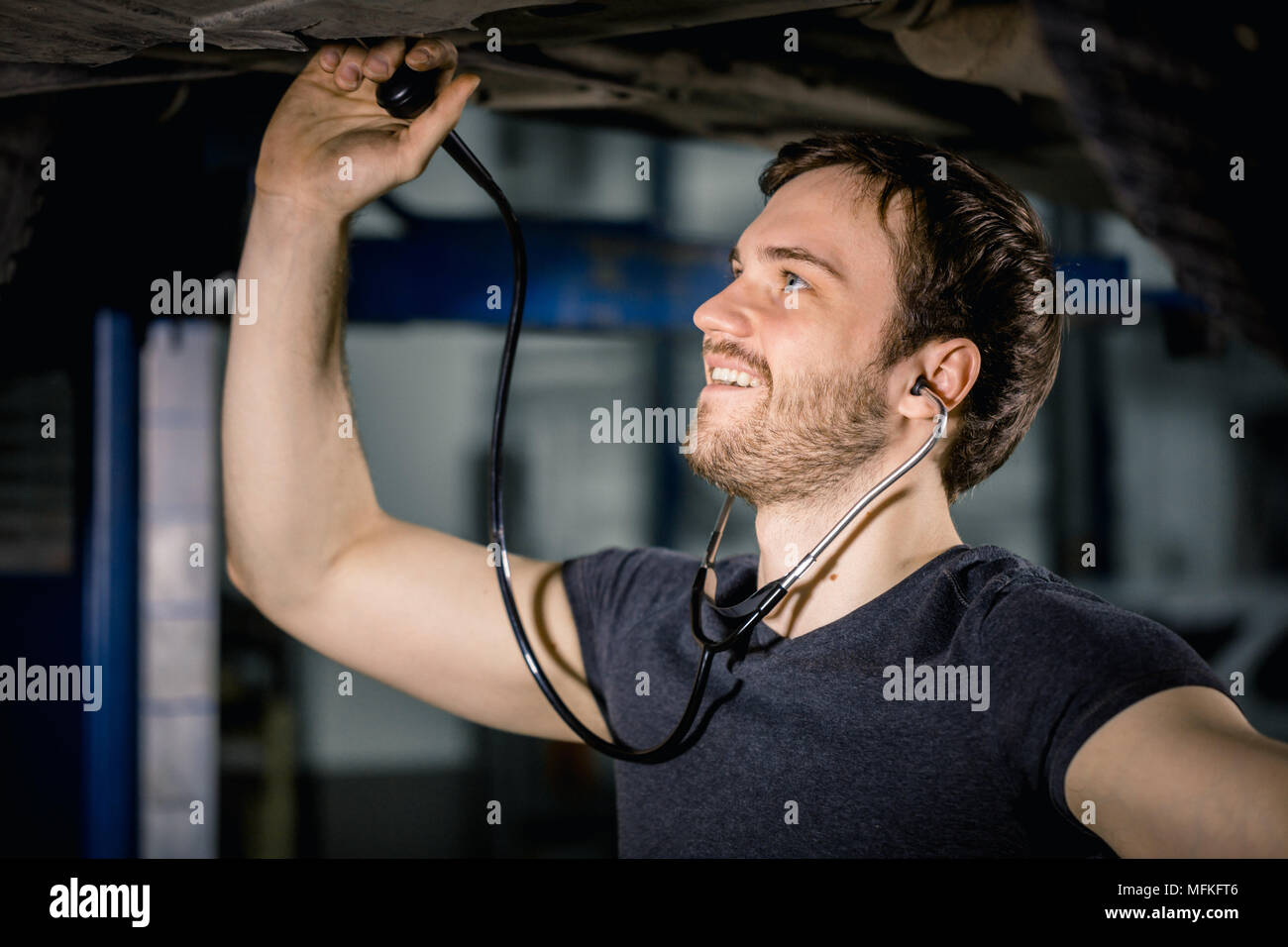 mechanic listen engine with stethoscope in repair garage Stock Photo ...