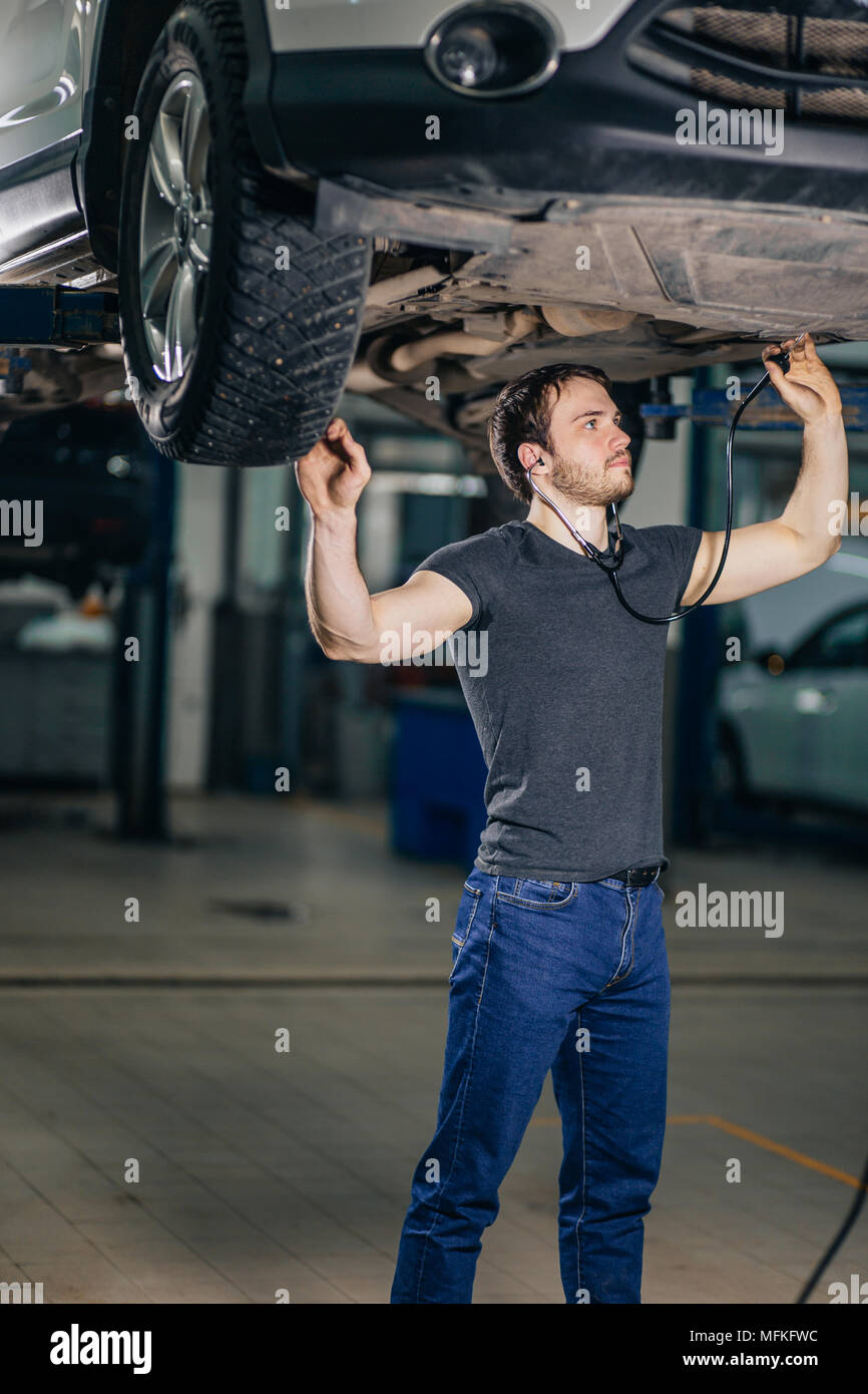 mechanic listen engine with stethoscope in repair garage Stock Photo ...