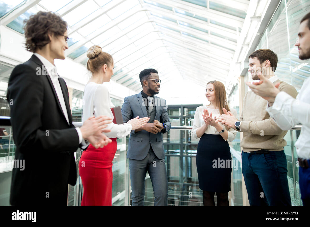 Happy business colleagues celebrating successful and clapping hands ...