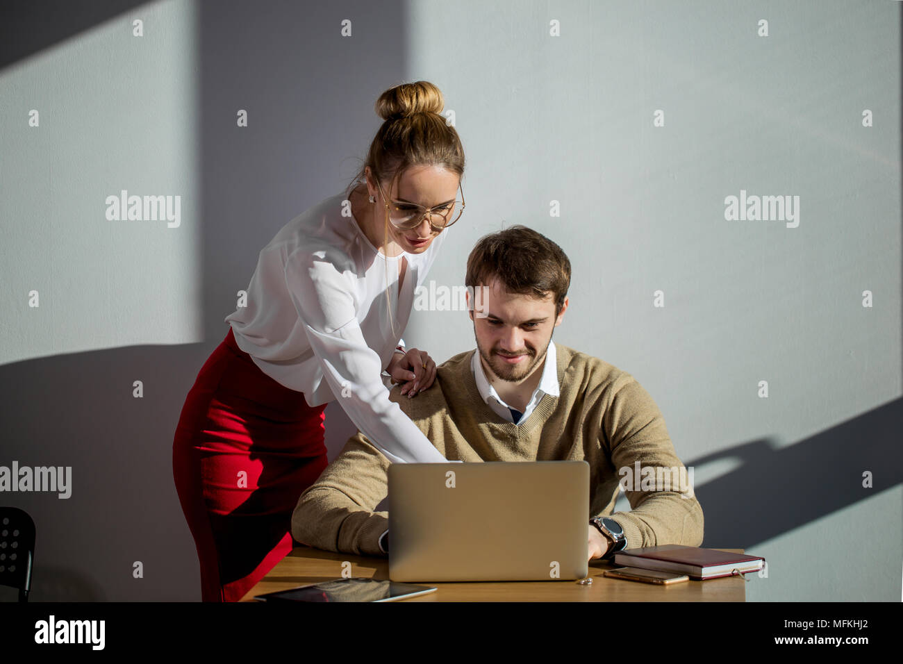 Female boss check work of her worker with laptop Stock Photo - Alamy