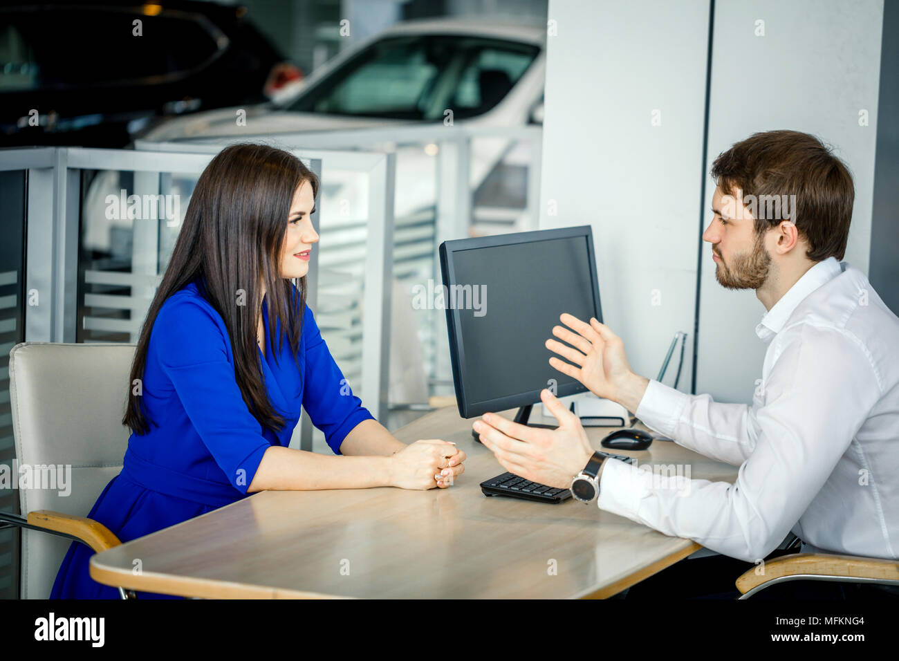 Car salesman explaining car features hi-res stock photography and ...