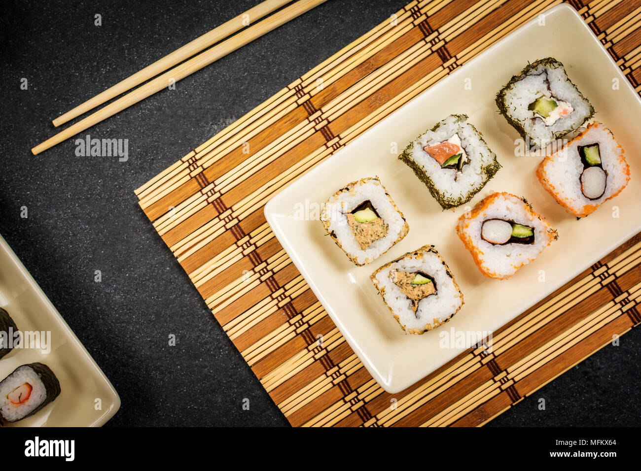 Traditional japanese sushi rolls hosomaki,uramaki and chopsticks on ...