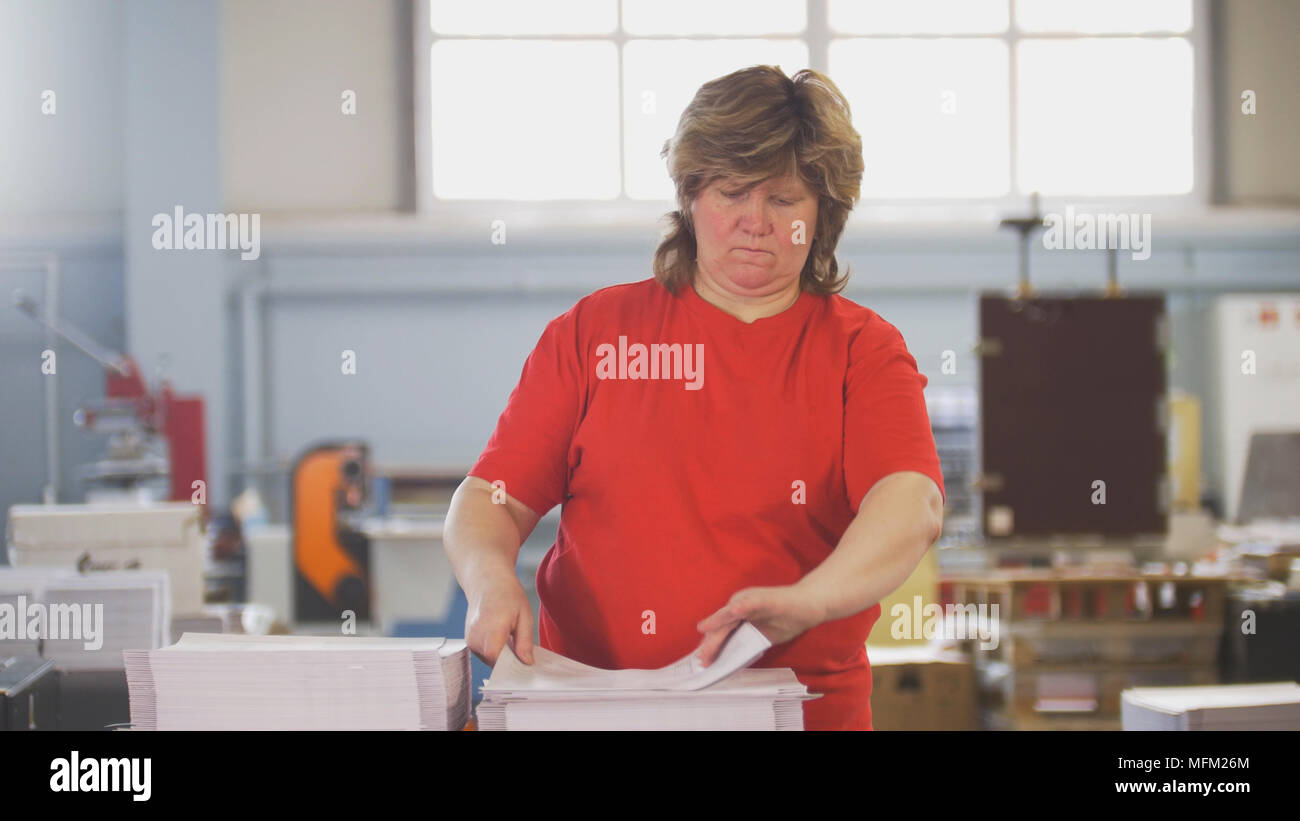 Female workers sorting a paper stacks in the typography Stock Photo - Alamy