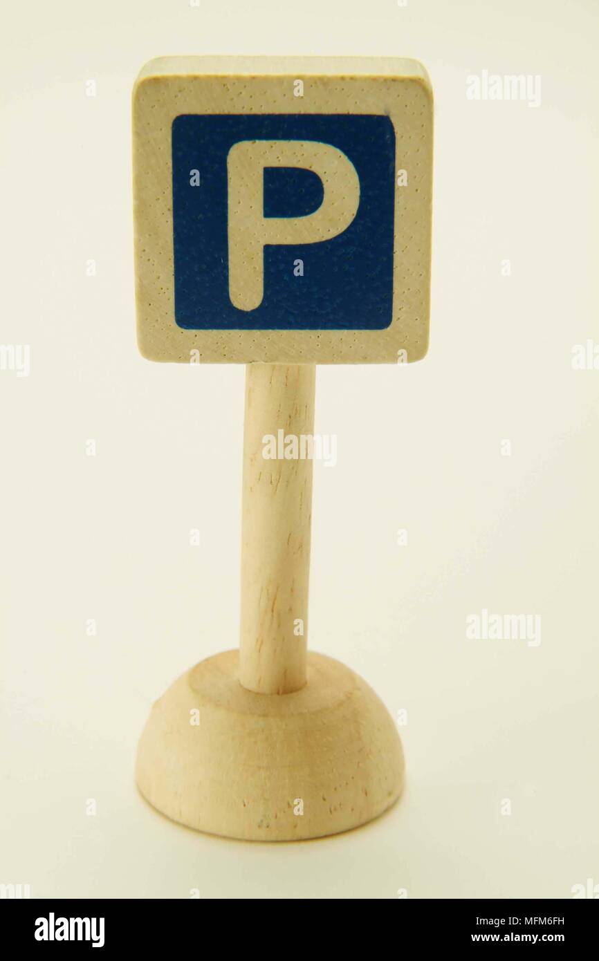 A straight on view of a simple wooden toy road sign showing parking ...