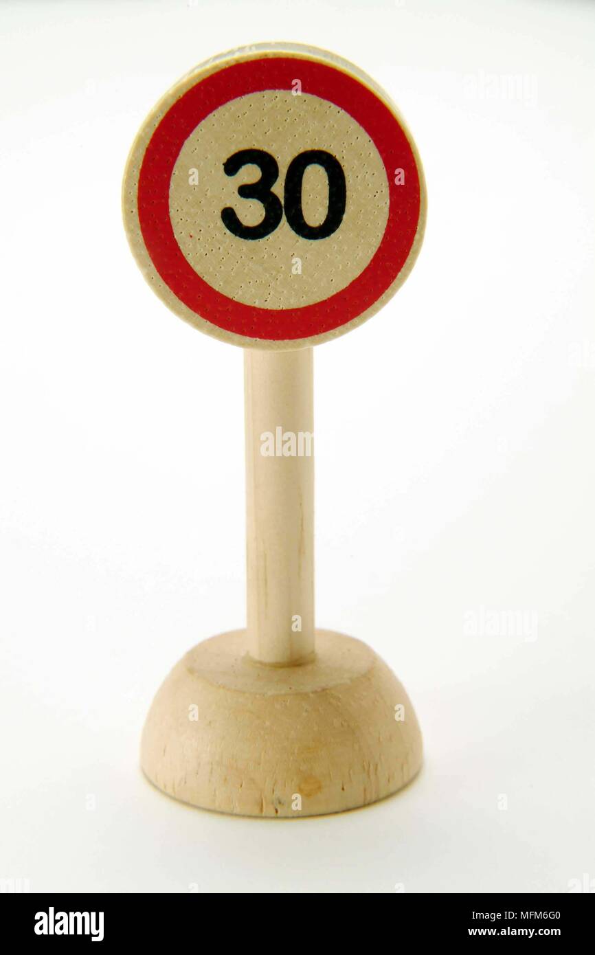 A straight on view of a simple wooden toy road sign showing a speed ...